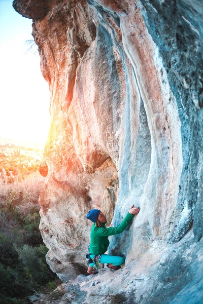 A woman climbs the rock. Climbing in nature. Fitness outdoors. Active ...