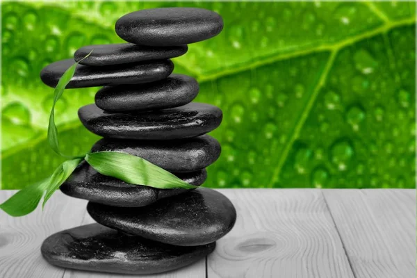 Zen stones and bamboo on wooden table - Stock Image - Everypixel