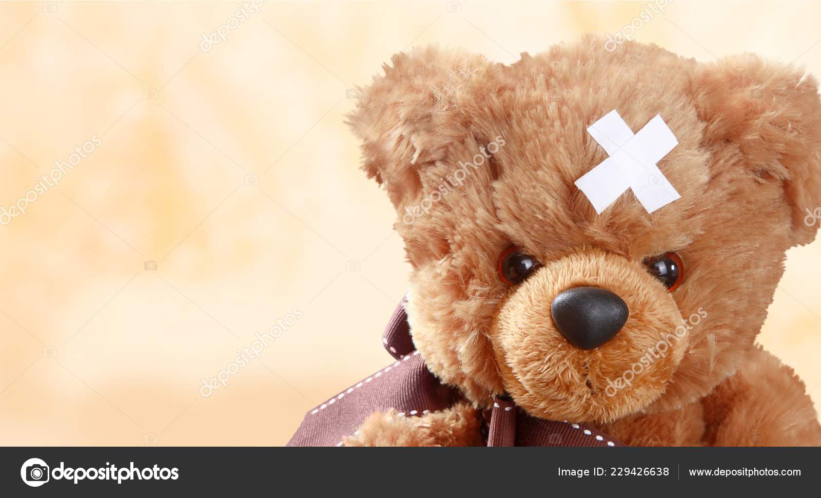 Cute Teddy Bear Plaster Forehead Stock Photo by ©billiondigital 229426638