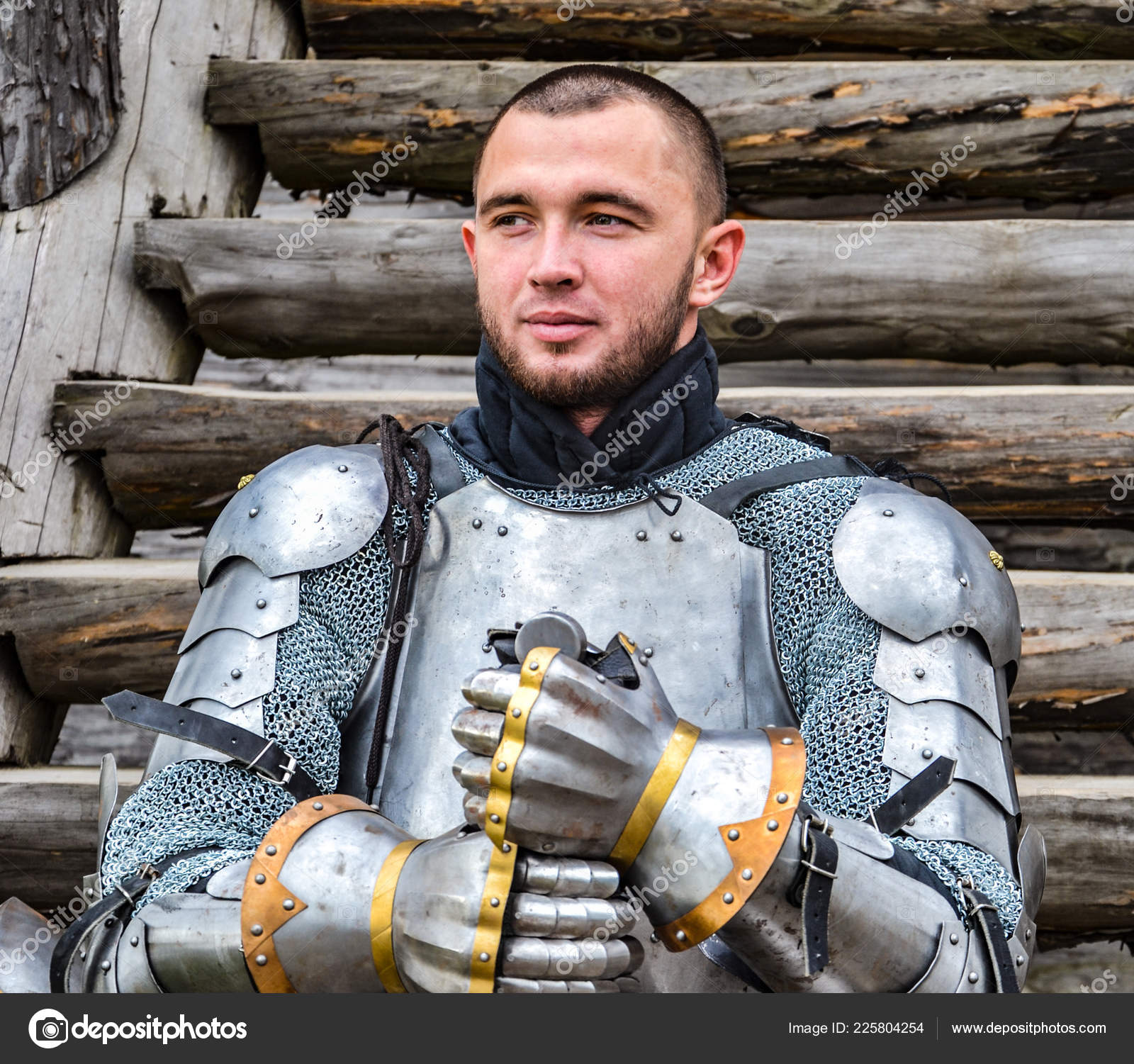 Knight in the armor on the wooden steps. Knightly armor and weapon ...