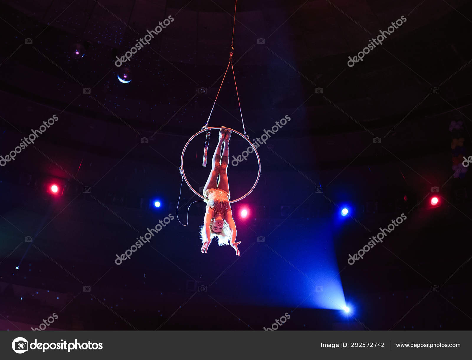 Aerial acrobat in the ring. A young girl performs the acrobatic ...