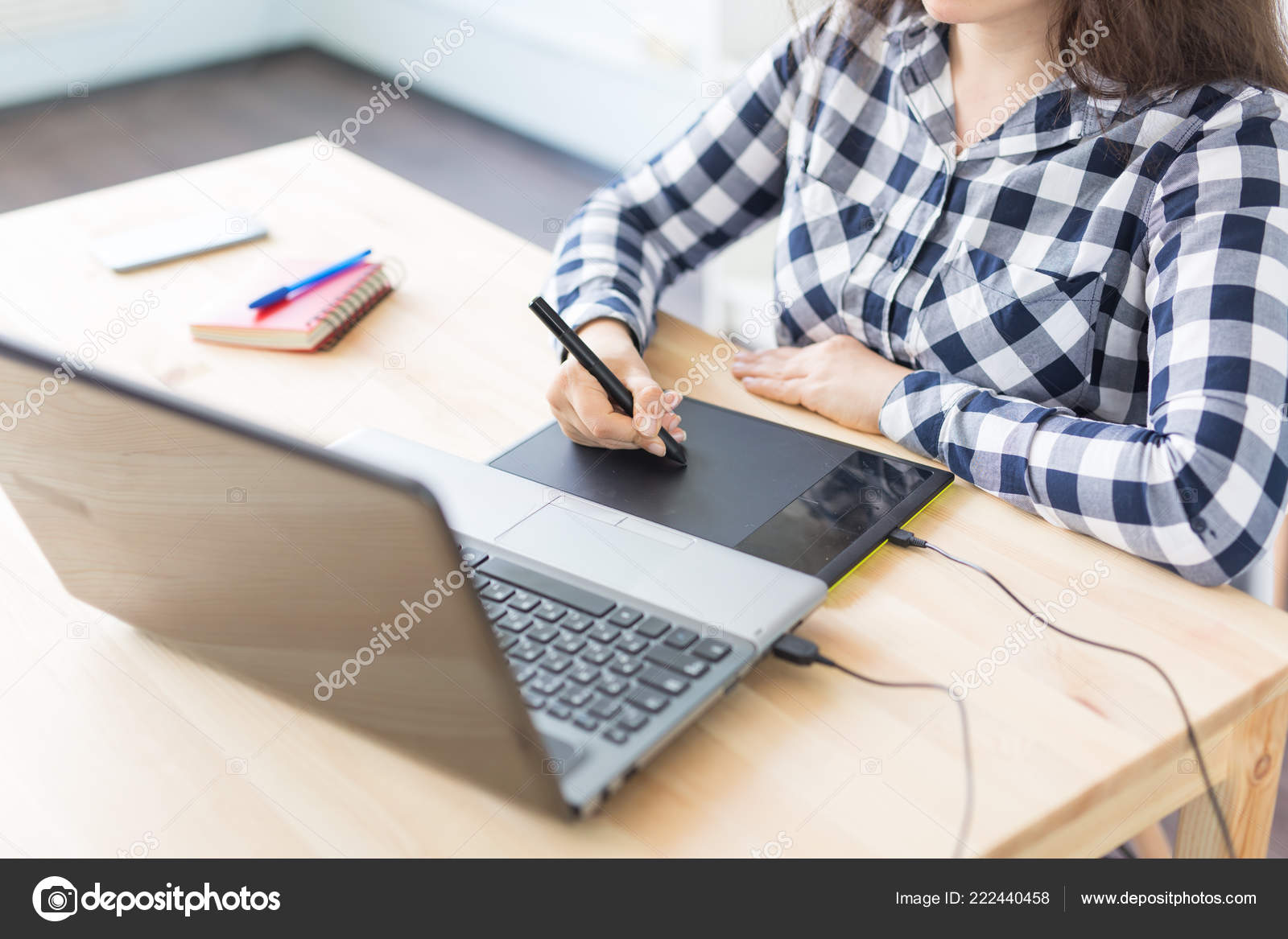 Close-up of female hands using digital graphic tablet at modern office ...