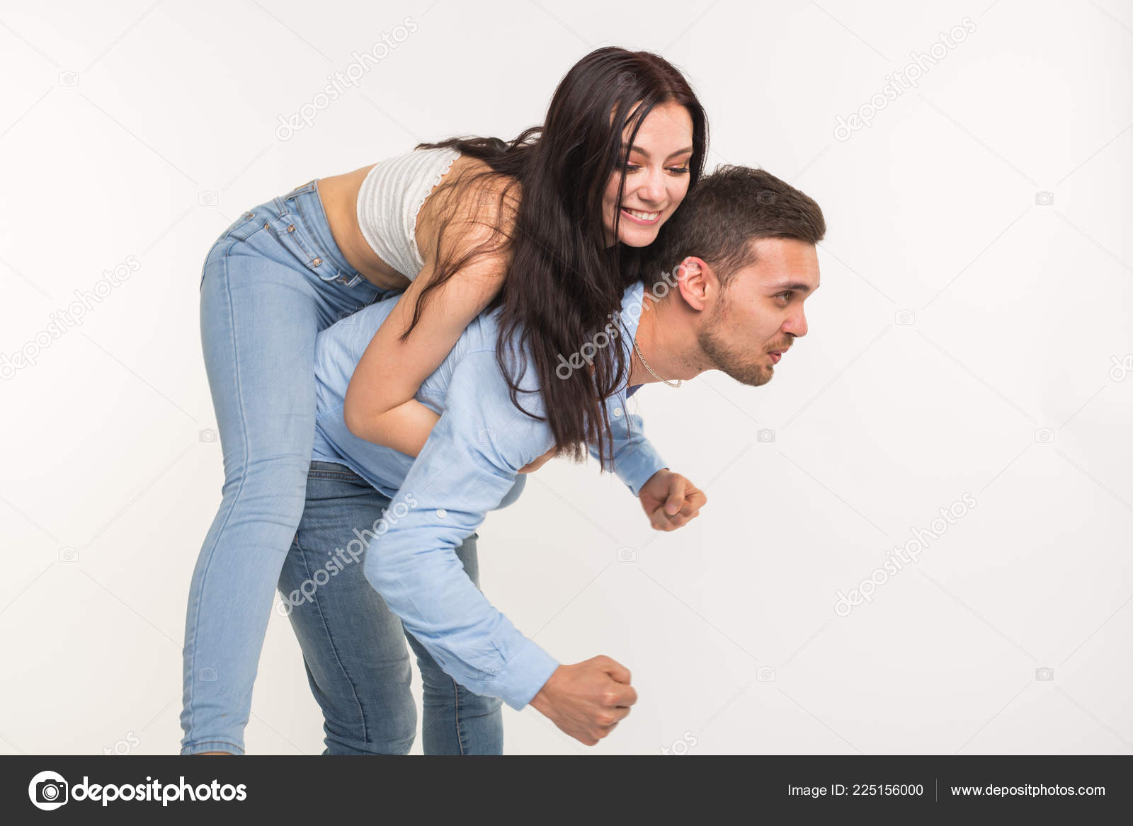 Couple posing on white background - man holding woman on his back ...