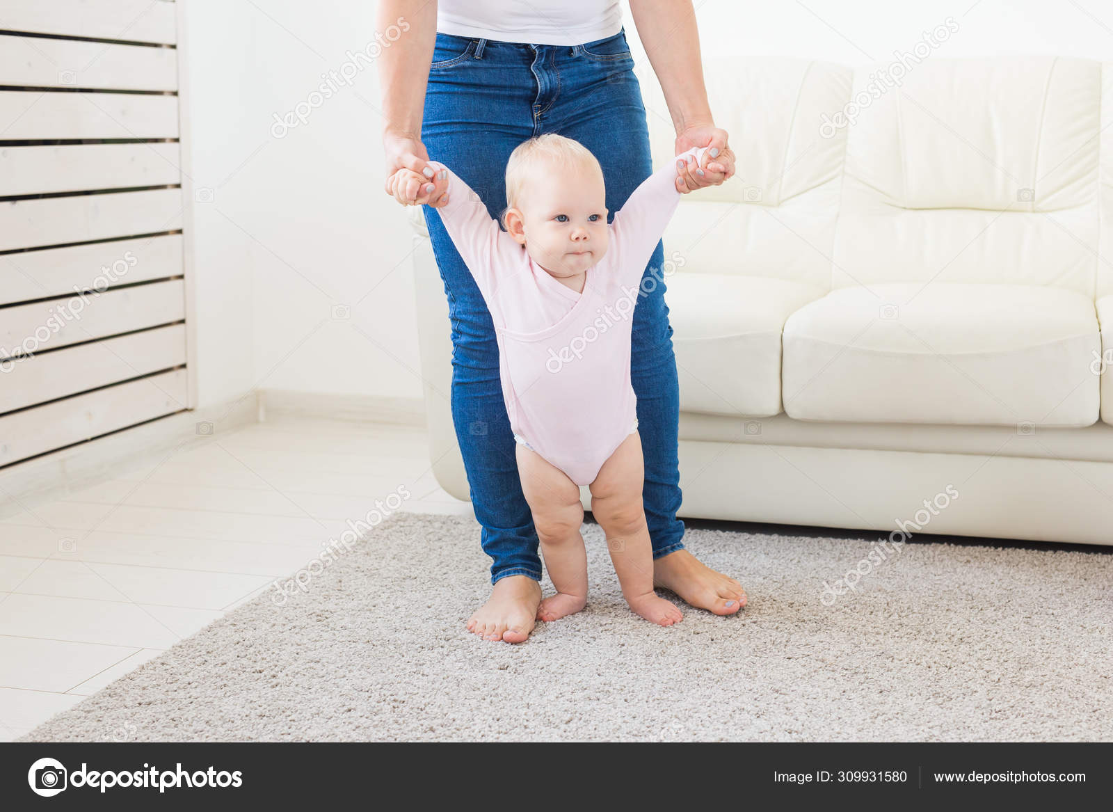 Baby taking first steps with mothers help at home — Stock Photo ...