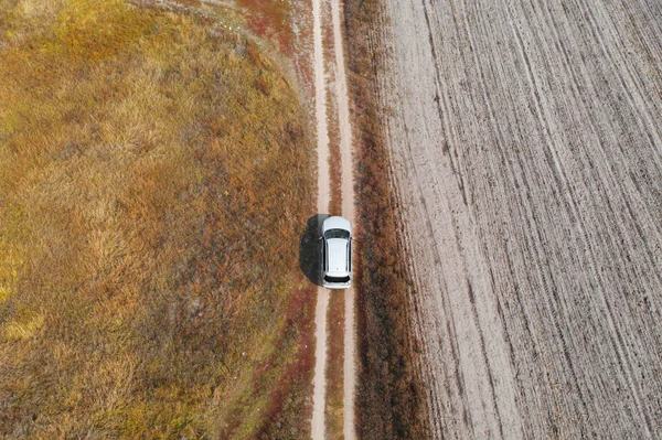 Aerial, Top Down view car driving down in rough terrain - Stock Image ...