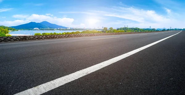 Empty asphalt road square and natural landscape under the blue s ...