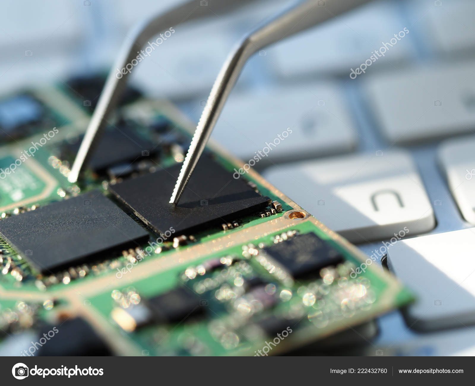 Small microchip board with tweezers lying on silver keyboard — Stock ...