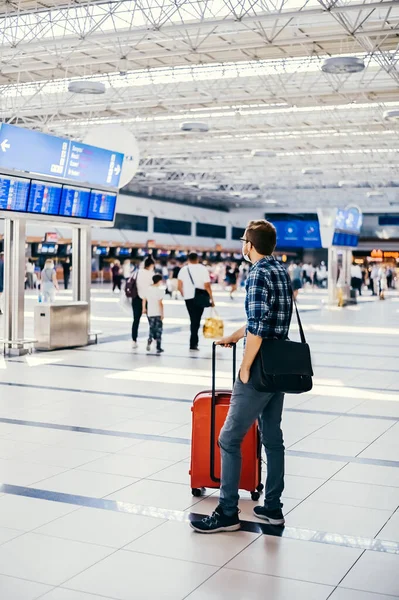 Airport european nerd man in glasses and plaid shirt with luggage tourist boarding plane taking ...