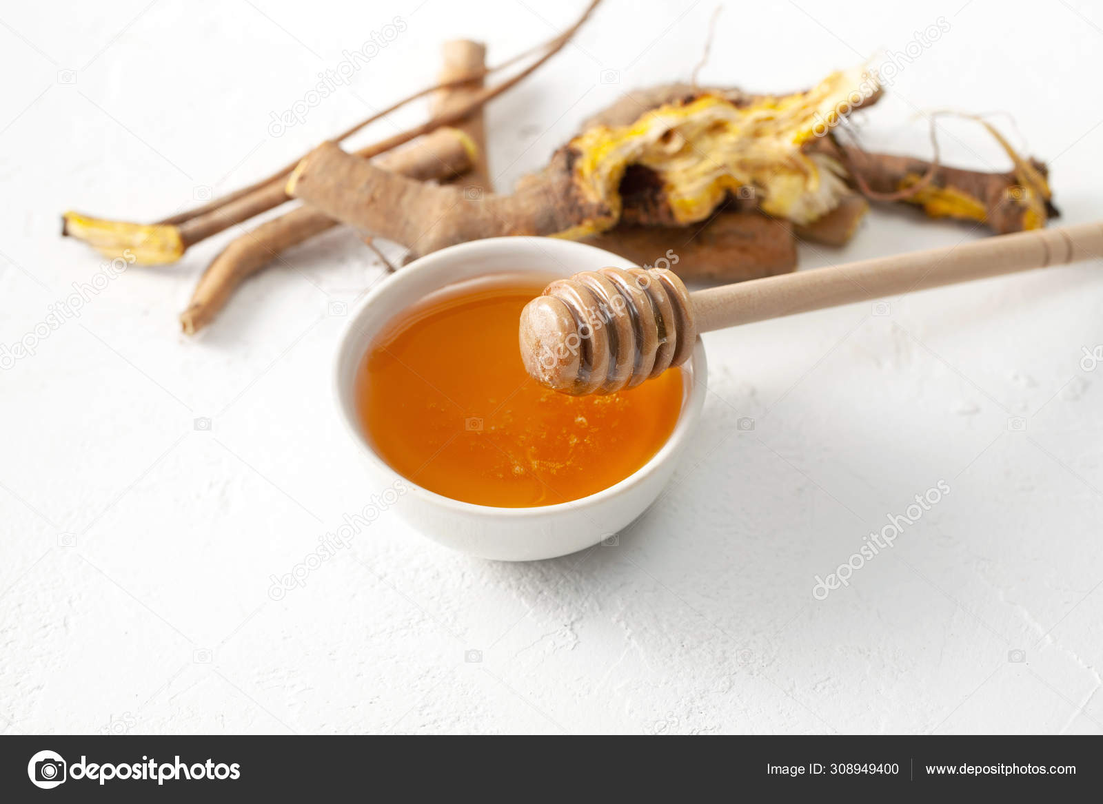 Raw root plant Rumex crispus (yellow dock) and honey on white concrete ...