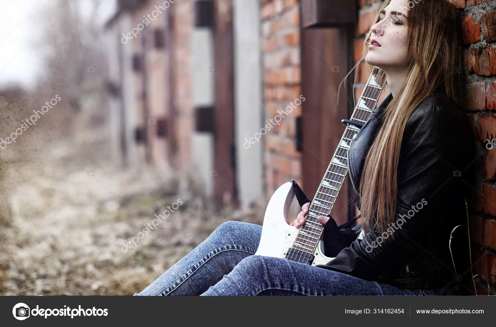 Beautiful young girl rocker with electric guitar. A rock musicia ...