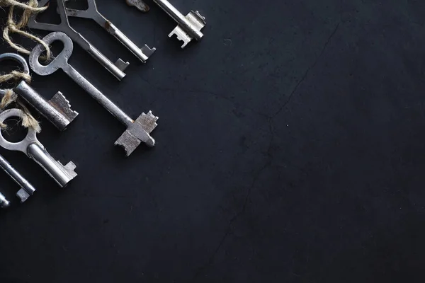 Set of vintage keys for lock. Retro keys on a dark stone background ...