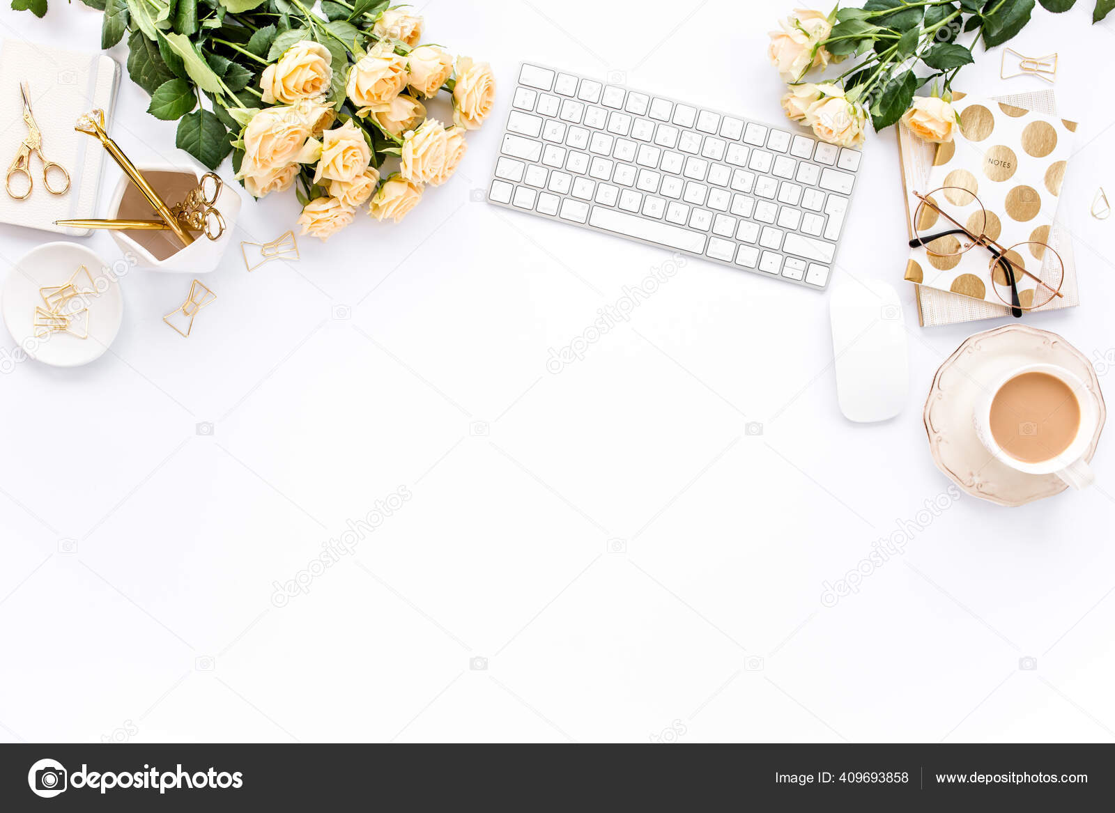 Female workspace with computer, roses flowers, golden accessories ...