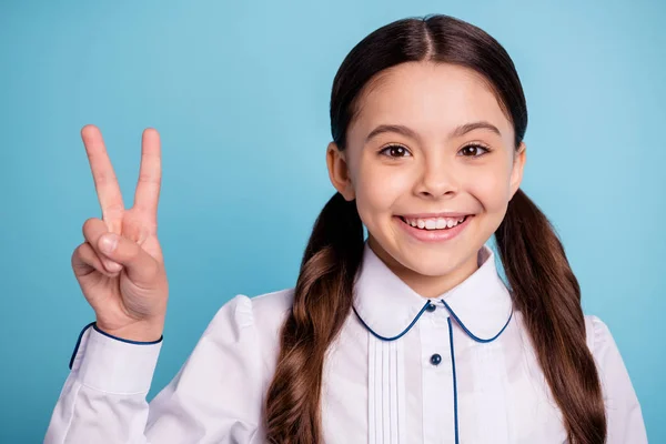 Photo of funny adorable school girl wear blue uniform showing v-signs ...
