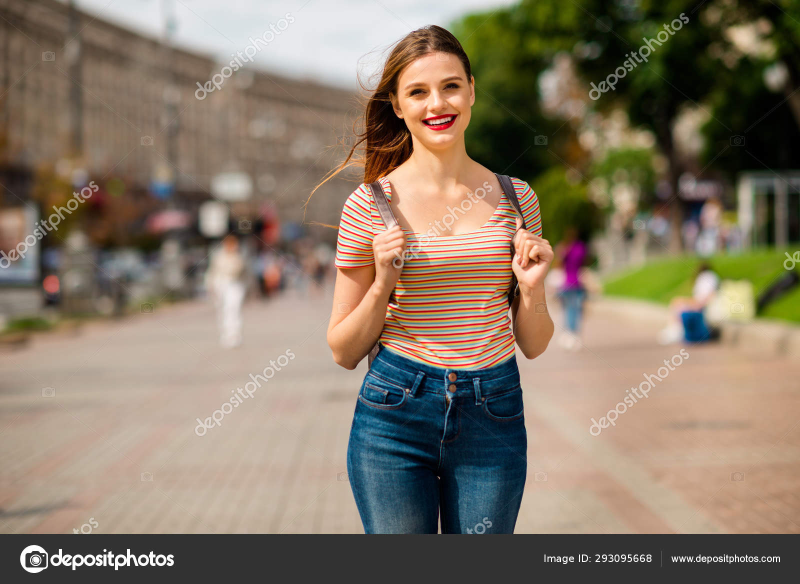 Portrait of charming millennial looking at camera with toothy smile in ...