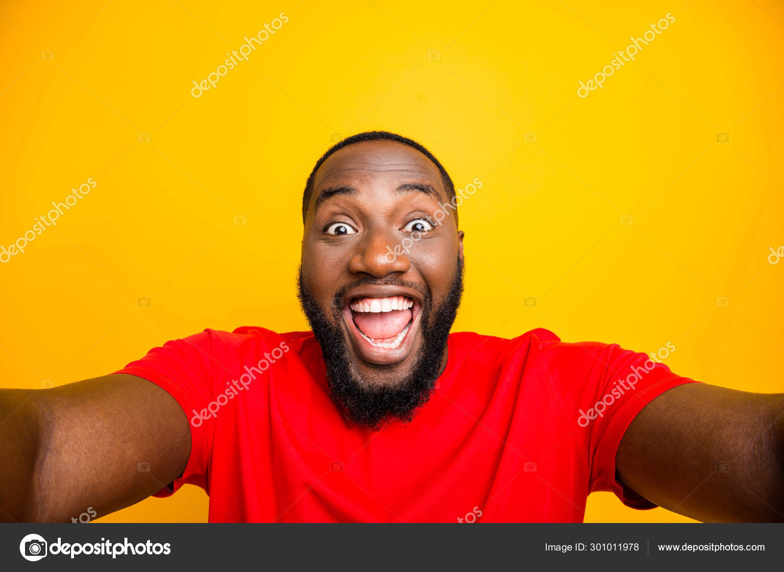 Self portrait of rejoicing overjoyed black man playing new camera with ...