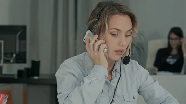 Busy call operator dealing with a lot of phone calls - Stock Image ...