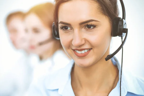 Call center. Focus on beautiful business woman in headset - Stock Image ...