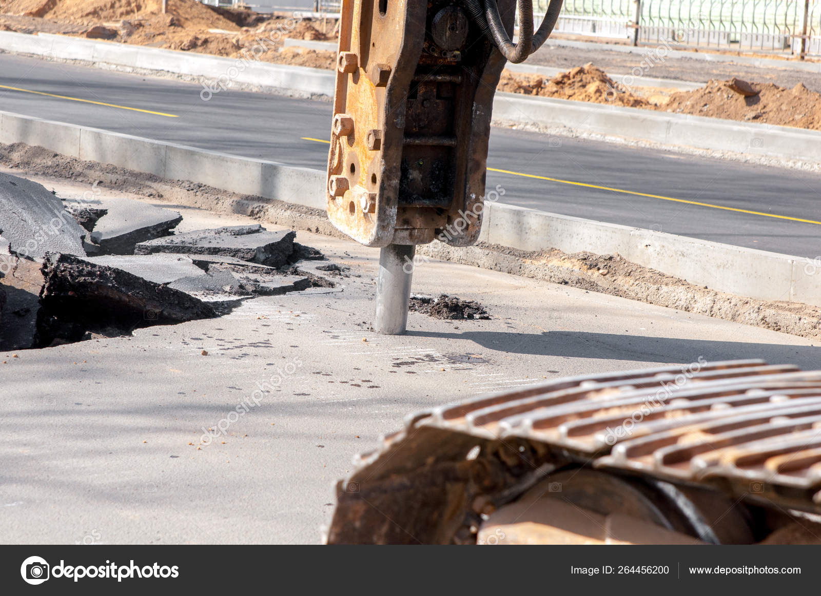 Male worker repairing driveway surface with jackhammer, digging and ...