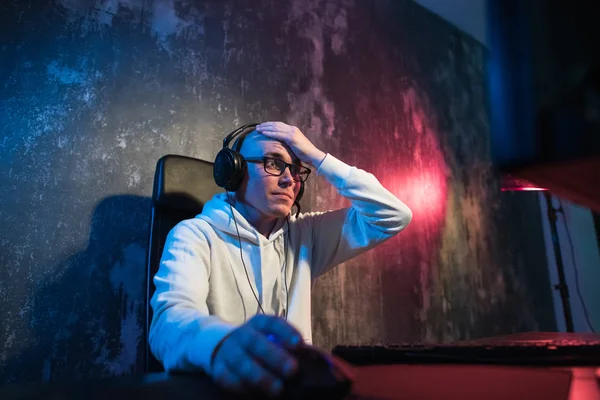 Young teen gamer wearing glasses standing posing with computer gaming ...