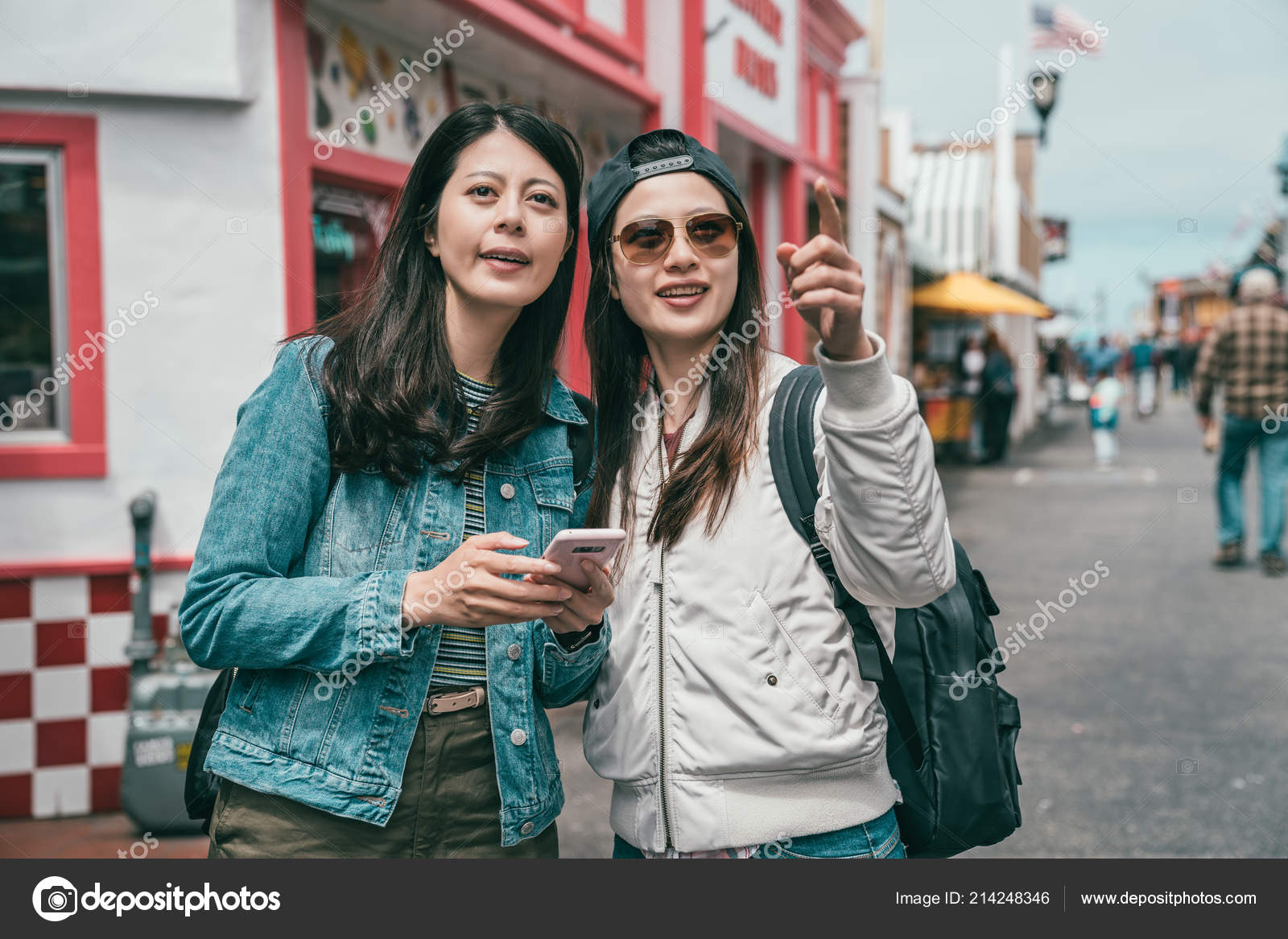 Two Young Friends Finding Out Destination Searching Cell Phone While ...