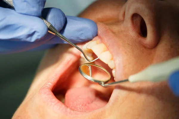 Patient getting her interdental spaces examined Stock Photo by ...