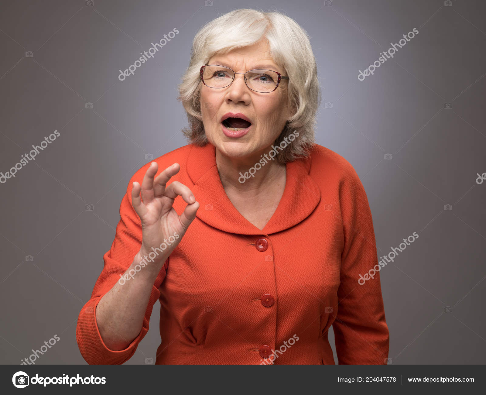Smiling Senior Lady Showing Sign Gray Background Stock Photo by ...