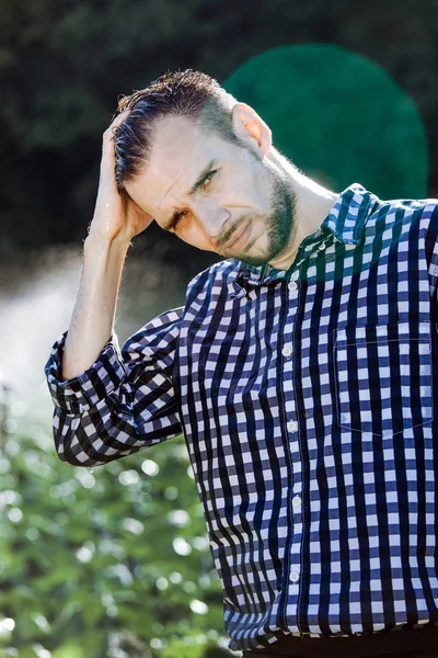 Portrait of a strong, drenched man in the rain. Young man getting wet ...