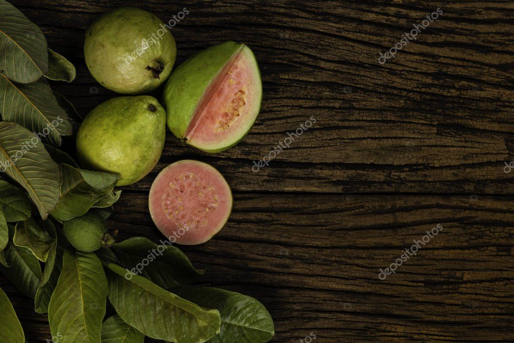 Guayabas rojas frescas con hojas verdes sobre fondo de demolici n de ...