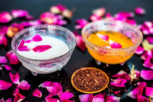 Milk face pack for clear complexion on shiny black wooden surface i.e ...