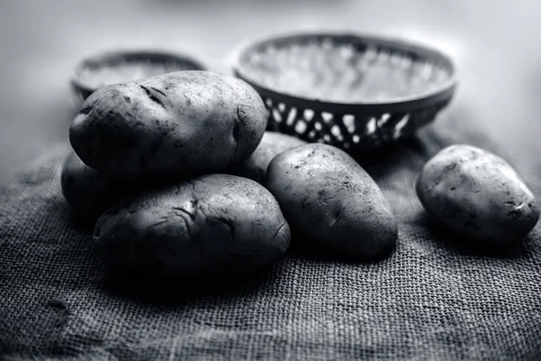 close-up of potatoes near hampers on jute bag surface - Stock Image ...