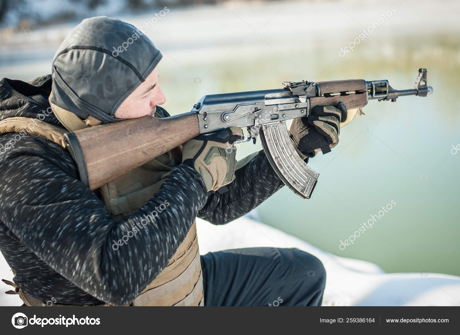 Army soldier in crouching position shooting from rifle machine gun ...