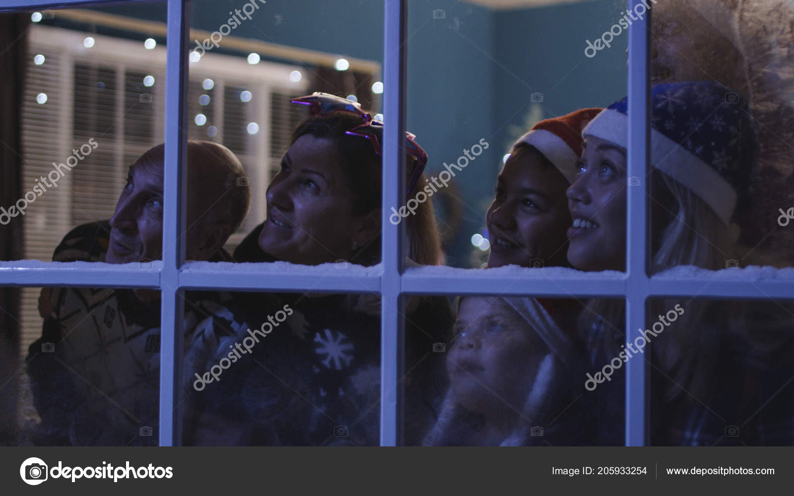 Happy family watching fireworks through window Stock Photo by ...