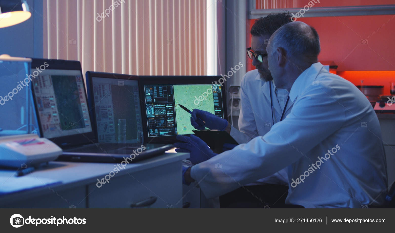 Scientists watching monitor and analyzing Stock Photo by ...