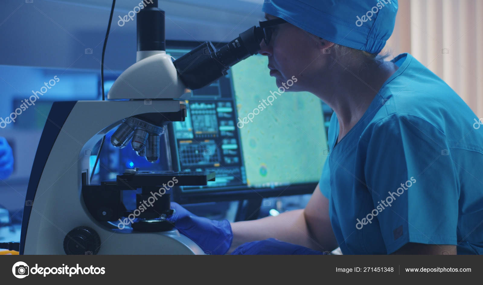 Biologist analyzing sample with microscope Stock Photo by ...