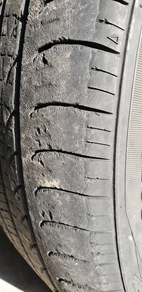 Damaged and worn out thread surface of automobile tire, close u - Stock ...