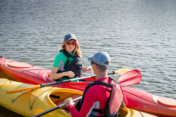 Two people in kayaks on the river - Stock Image - Everypixel