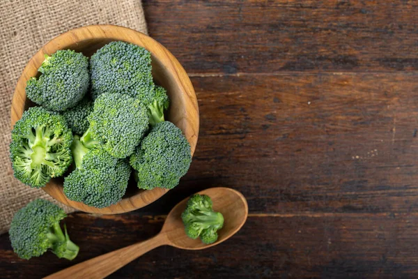 Fresh broccoli with in bowl on wooden table close up. Fiber-rich food ...