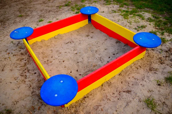 A nice sandbox playground filled . Surrounded by green grass, seen from ...