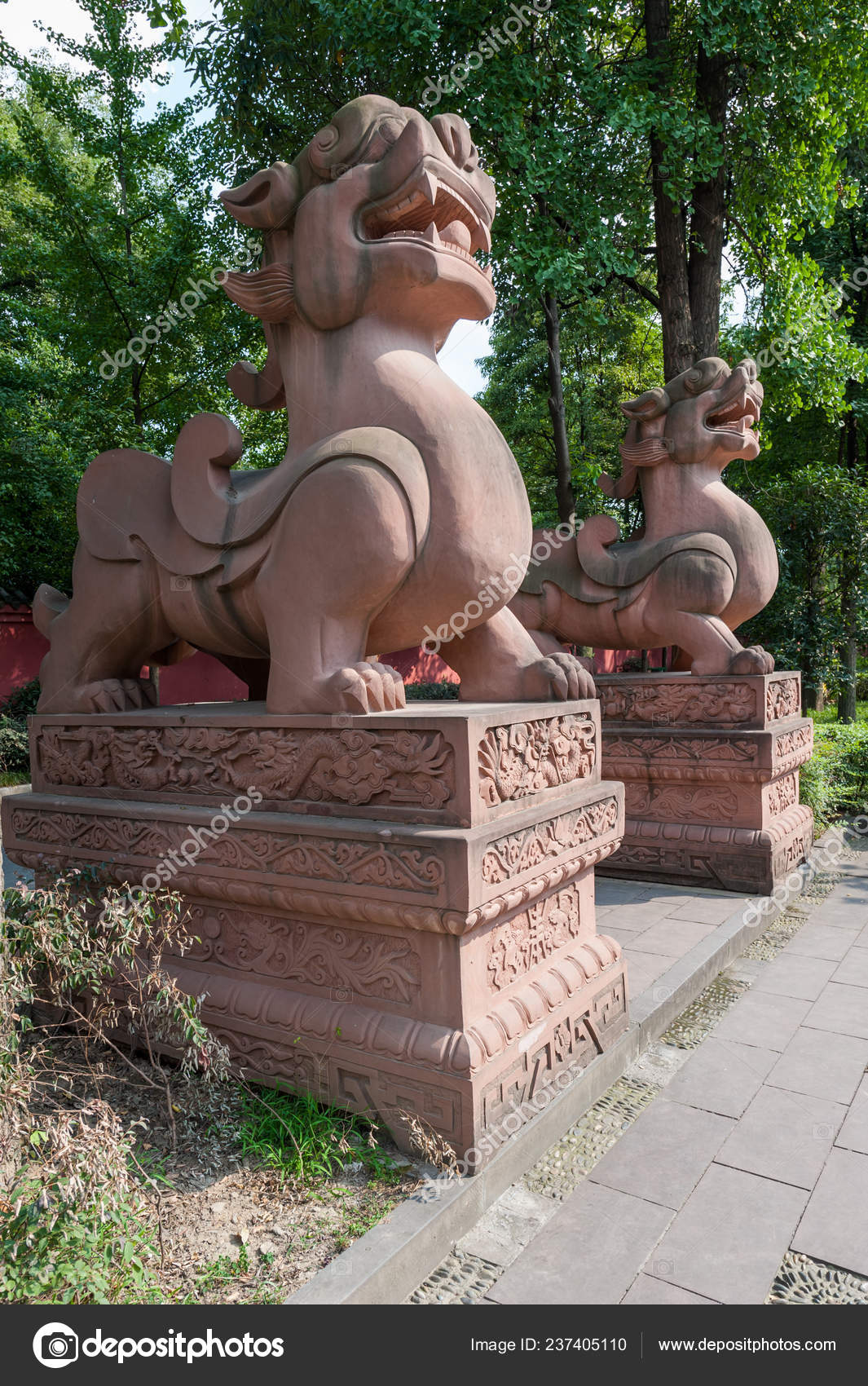Two large lion stone statues in a buddhist temple Stock Photo by ...