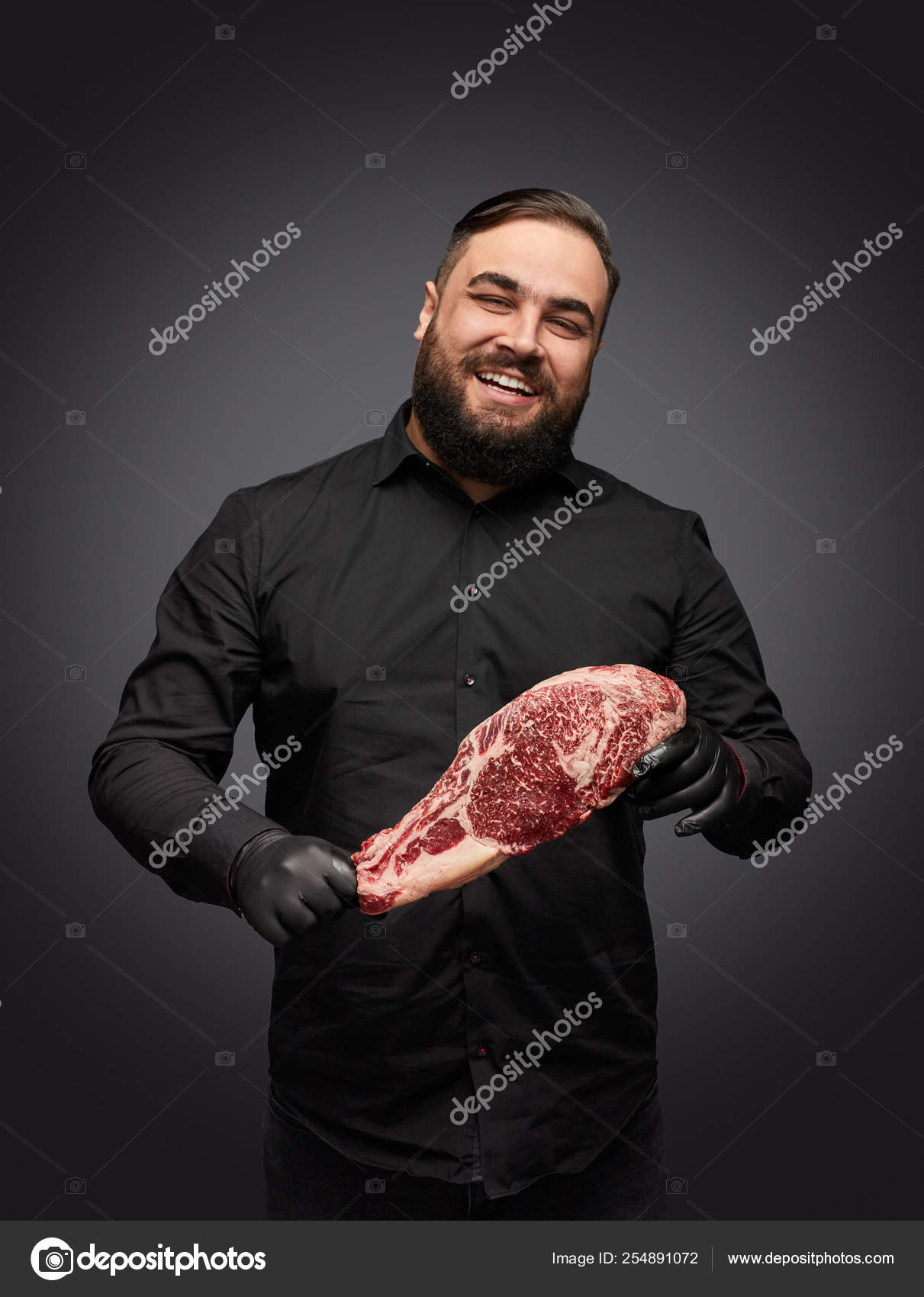 Smiling butcher with raw meat Stock Photo by ©kegfire 254891072
