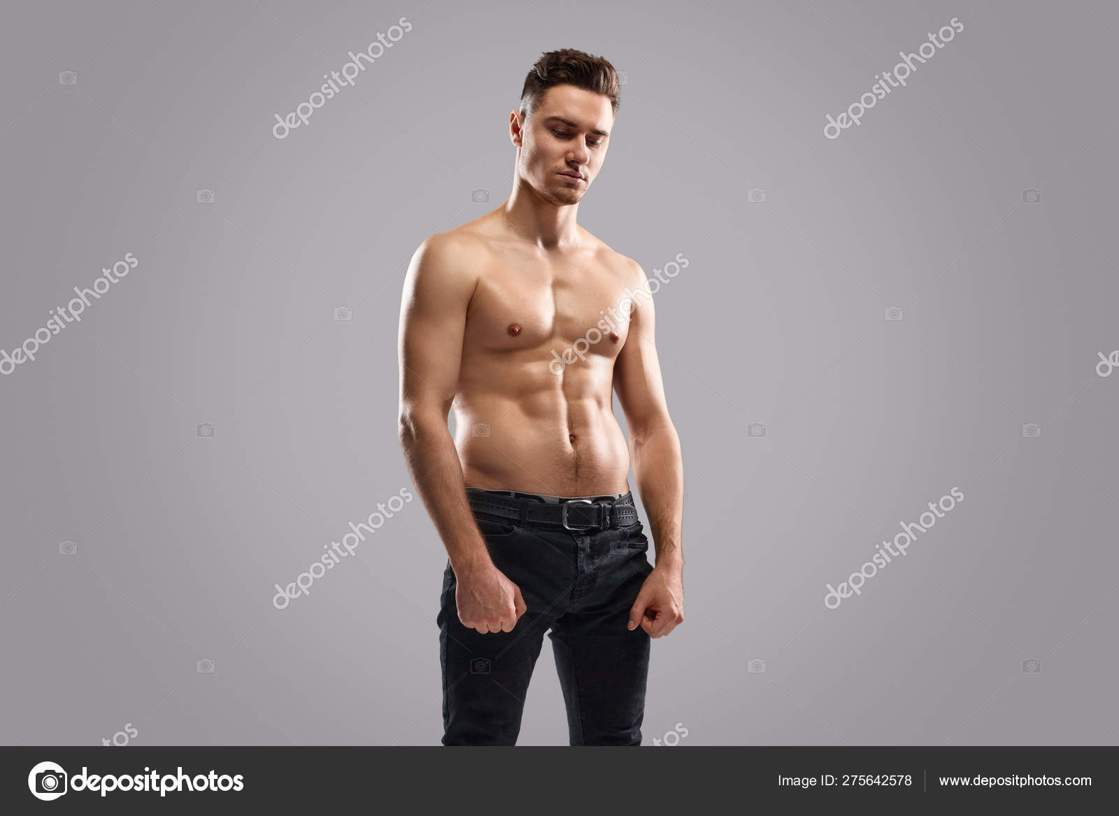 Muscular young male looking down Stock Photo by ©kegfire 275642578