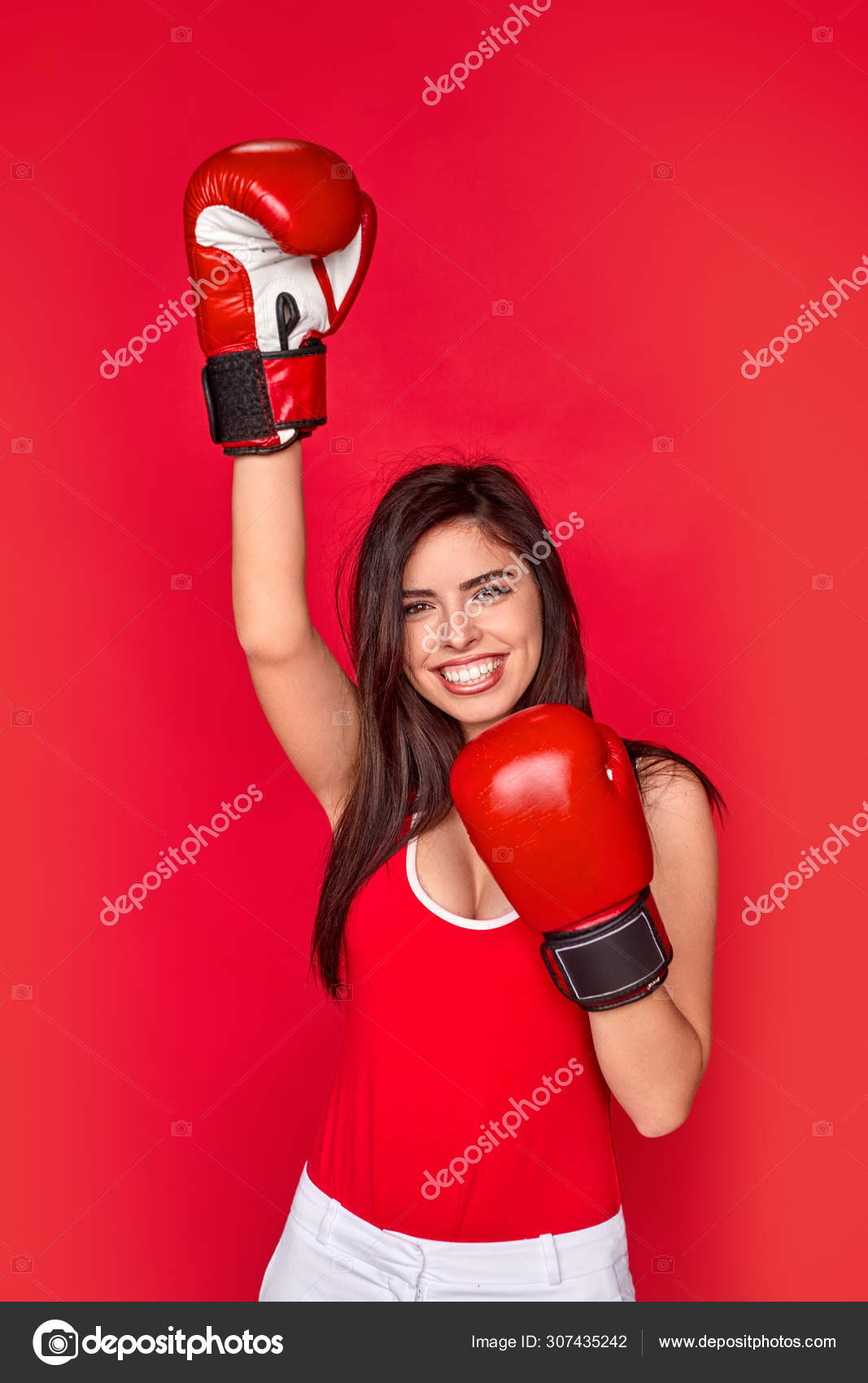 Athletic winner female boxer stretching hand up Stock Photo by ©kegfire ...