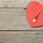 'Key to My Heart' love concept, with gold heart shape key and red heart ...