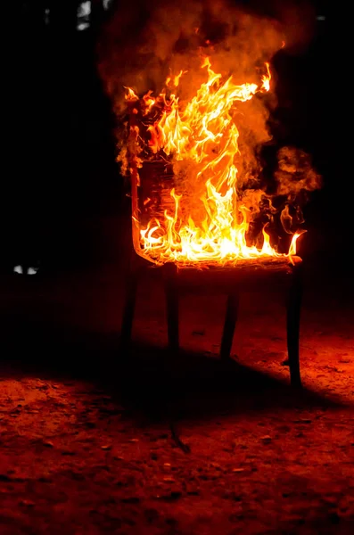 Wooden chair is on fire. Incineration of furniture. Conceptual photo ...