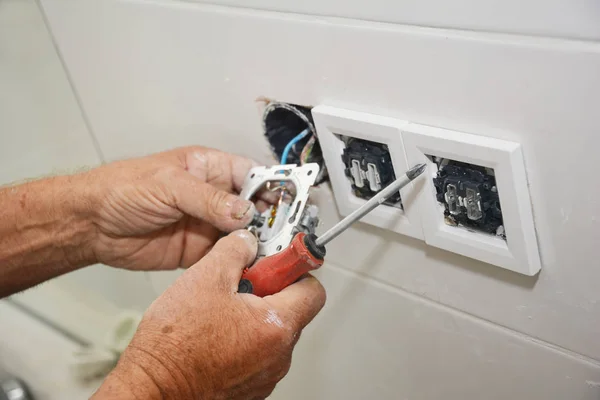 Electrican repair and installing socket, outlet plug - Stock Image ...