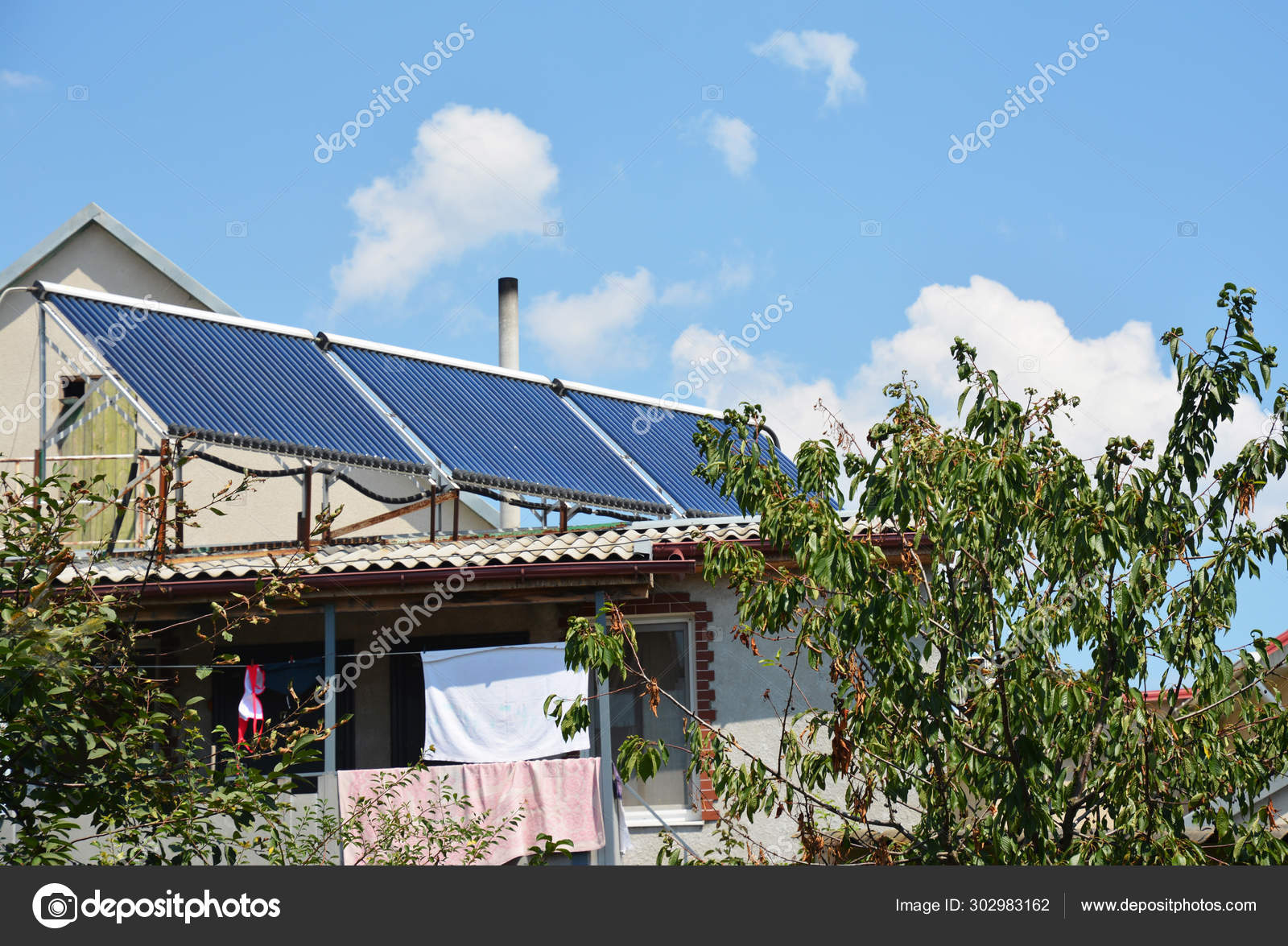 Solar water heater panels on the house roof — Stock Photo © thefutureis ...