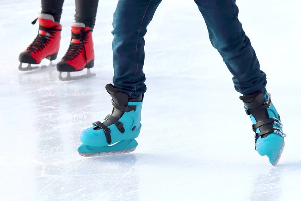 feet of different people skating on the ice rink - Stock Image - Everypixel
