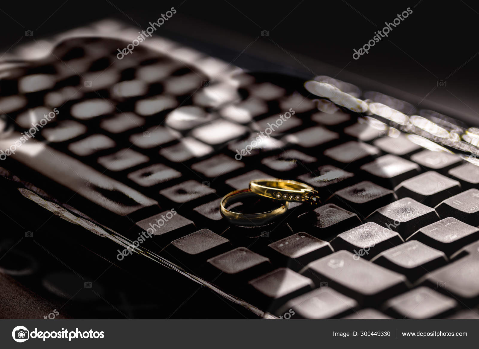 Golden wedding rings on a personal computer keyboard, with a double ...