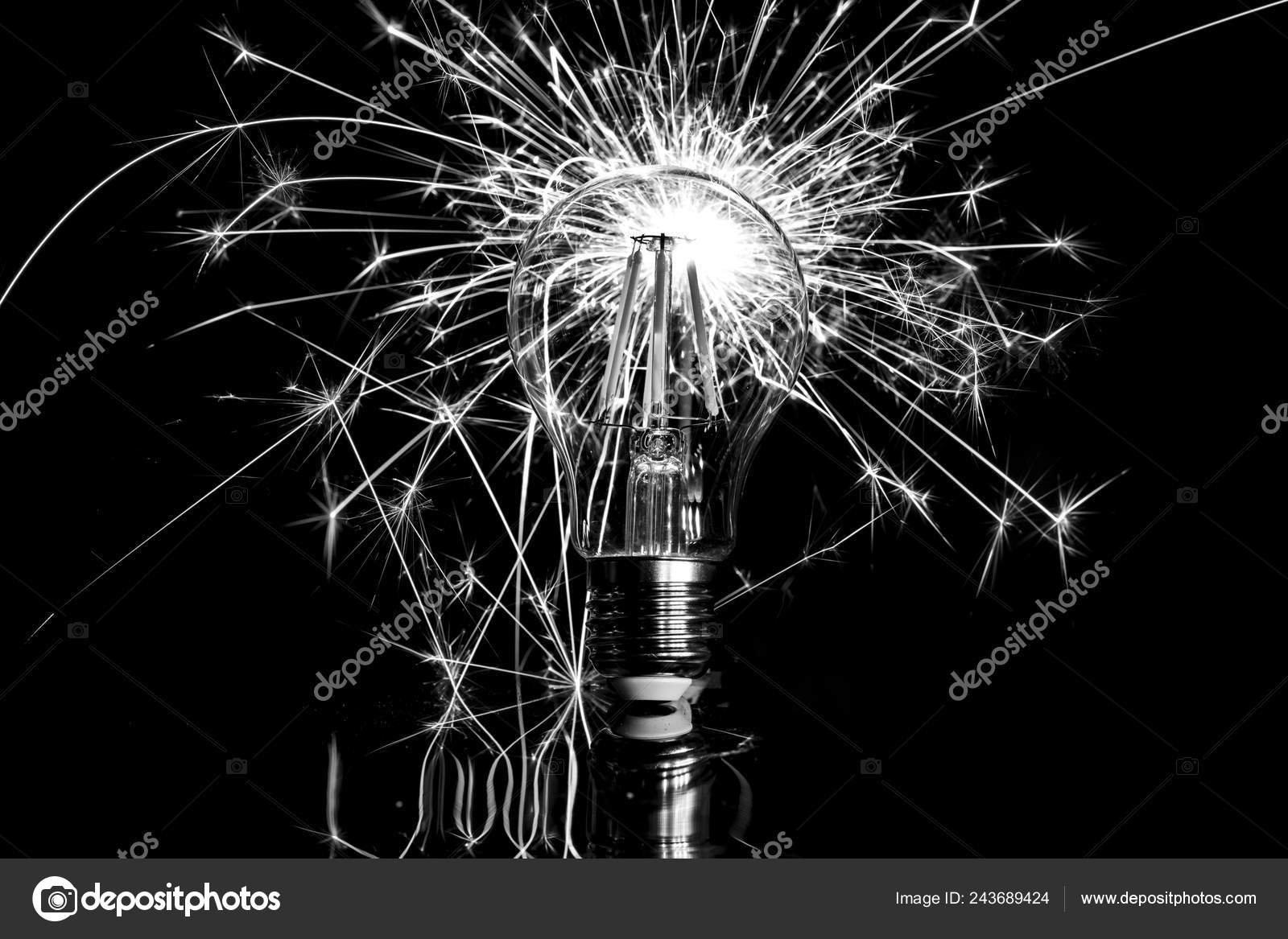 Fireworks sparkler showing through LED light bulb - black white Stock ...