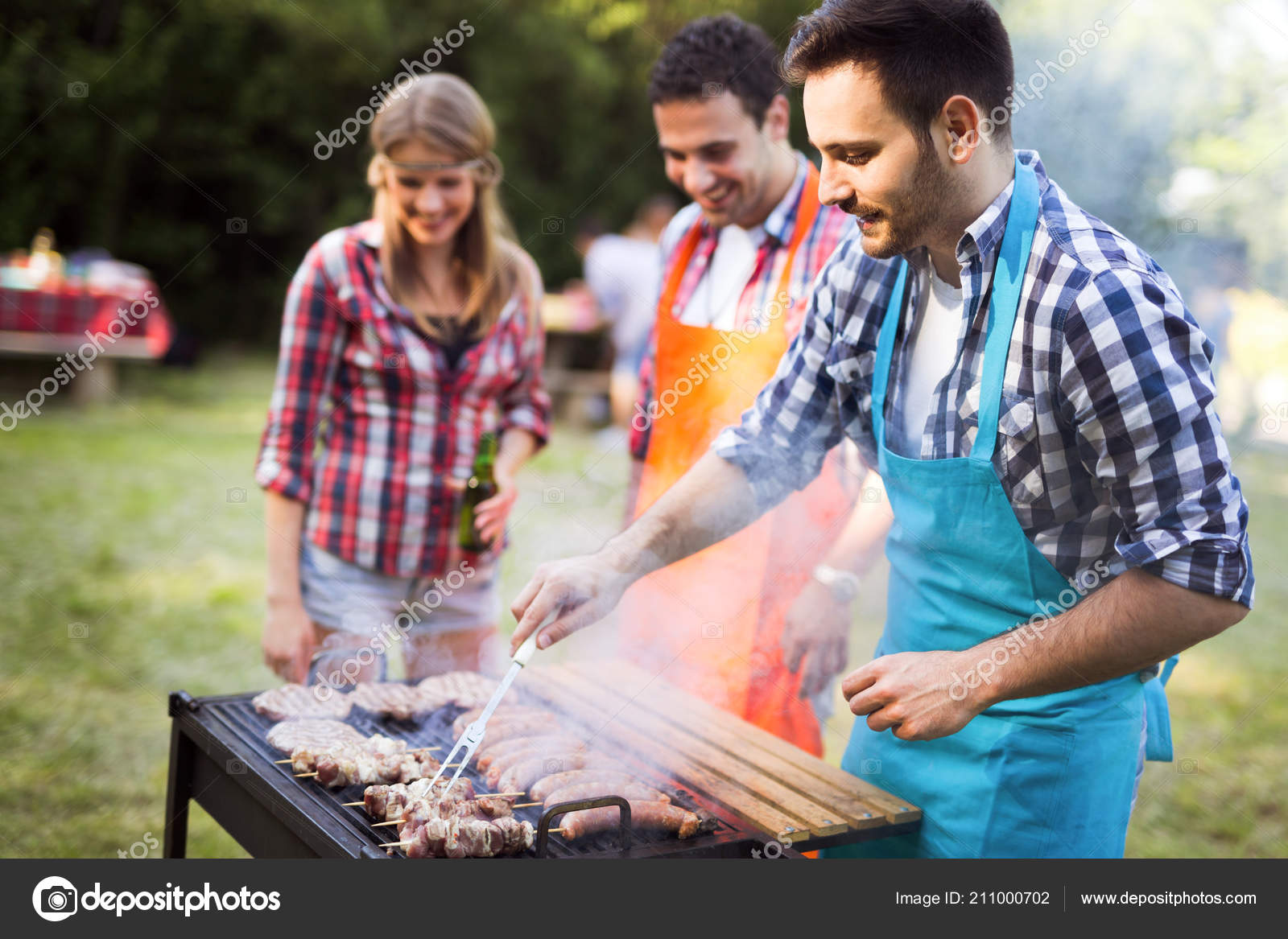 People having bbq party Stock Photo by ©nd3000 211000702